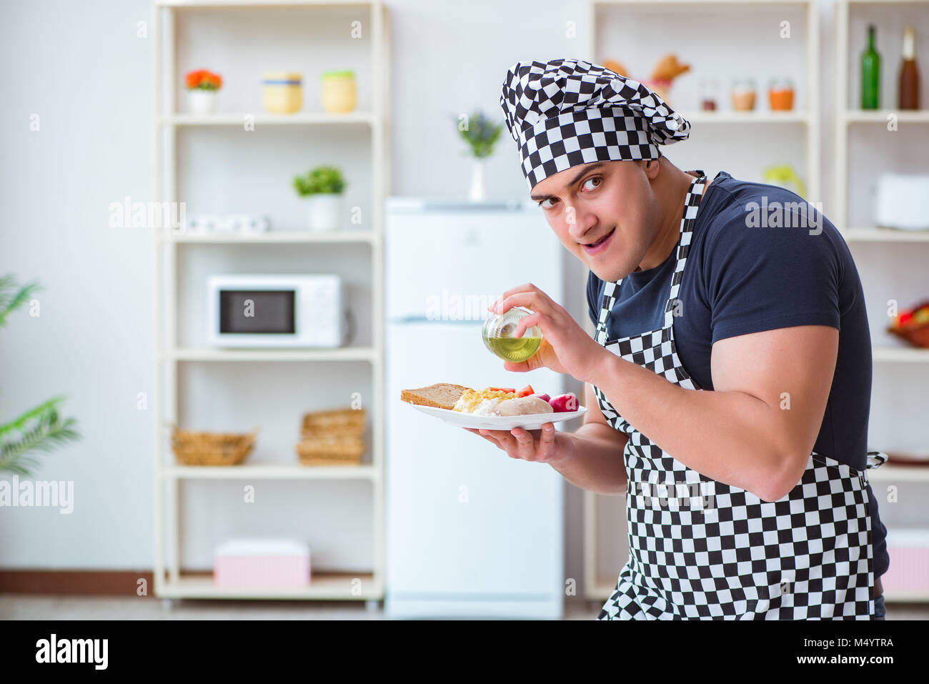 Chef cook cooking a meal breakfast dinner in the kitchen Stock Photo ...