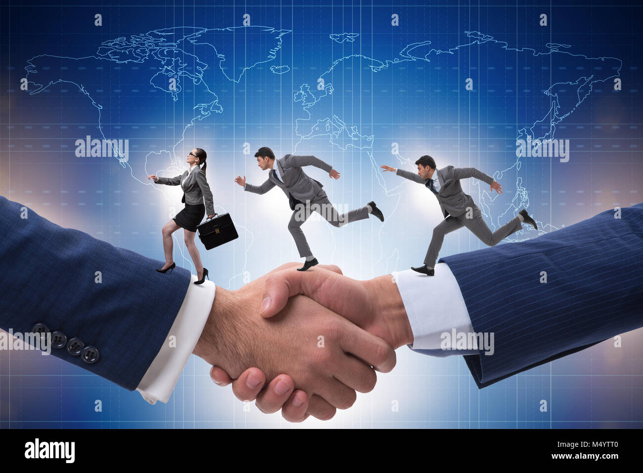 Cooperation concept with people running on handshake Stock Photo - Alamy