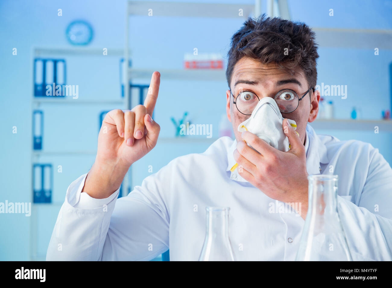 Funny mad chemist working in a laboratory Stock Photo - Alamy