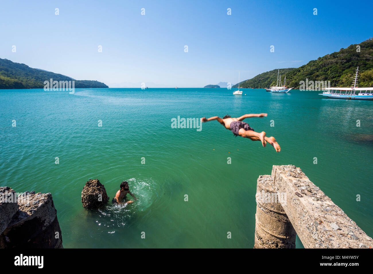 Man diving into water at Palmas Beach in Ilha Grande, Rio de Janeiro ...
