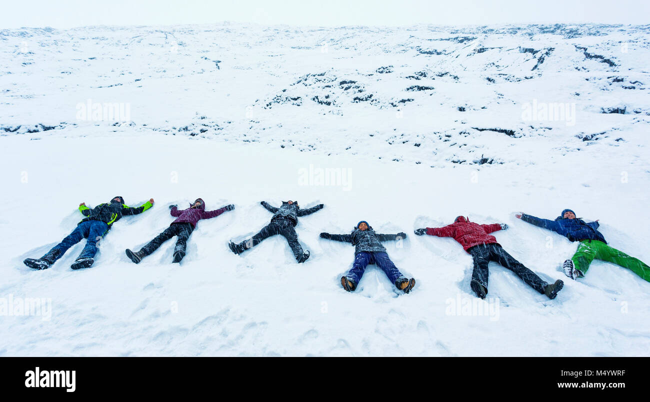 Six tourists making snow angels hi-res stock photography and images - Alamy