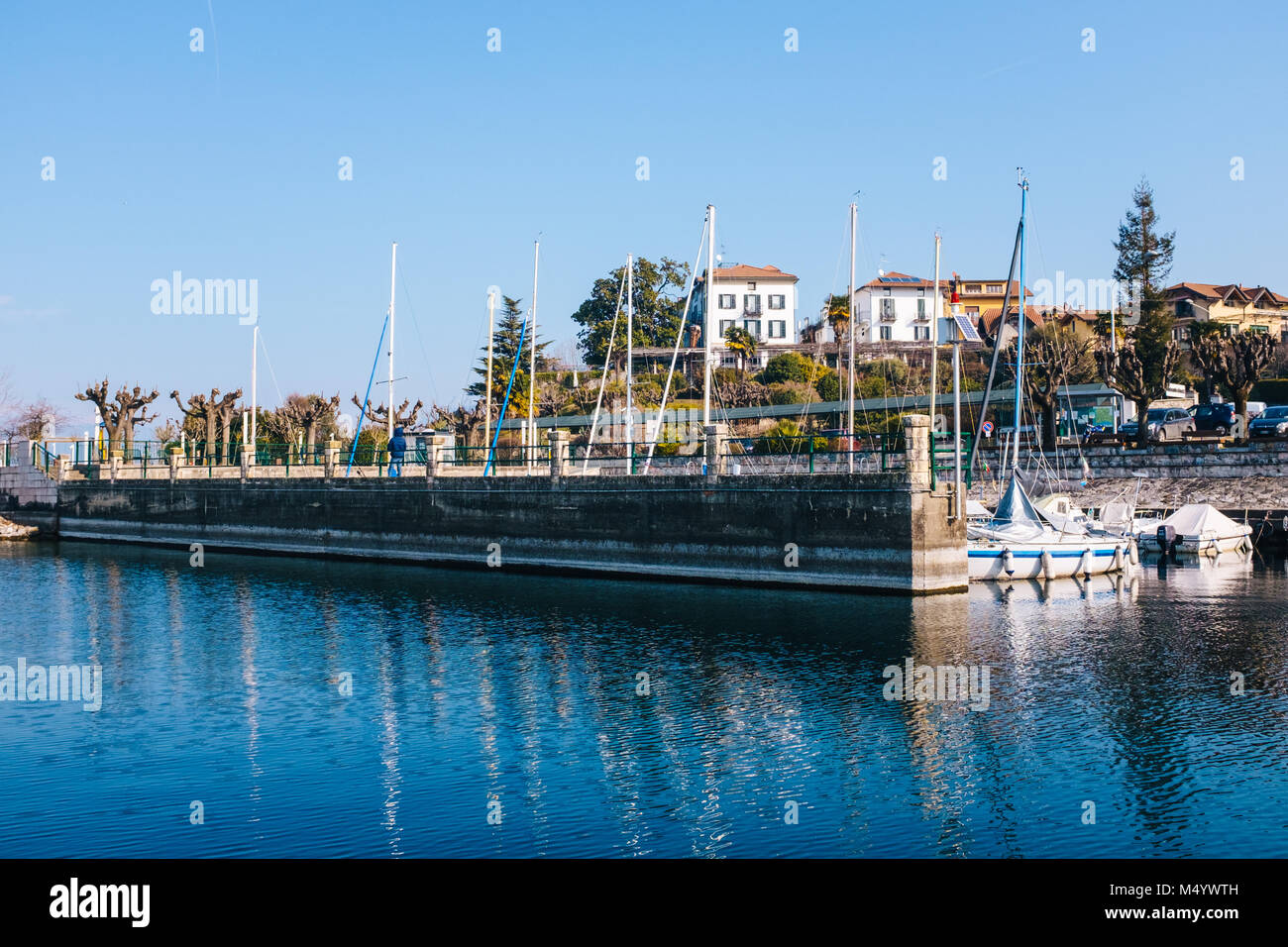 Port of sailboats with traditional and tourist village, Ranco, Lombardy ...