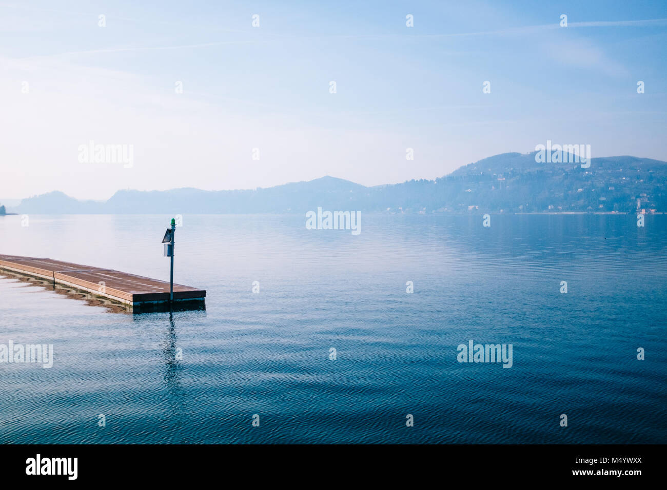 floating jetty with background the lake and mountains on a bright ...