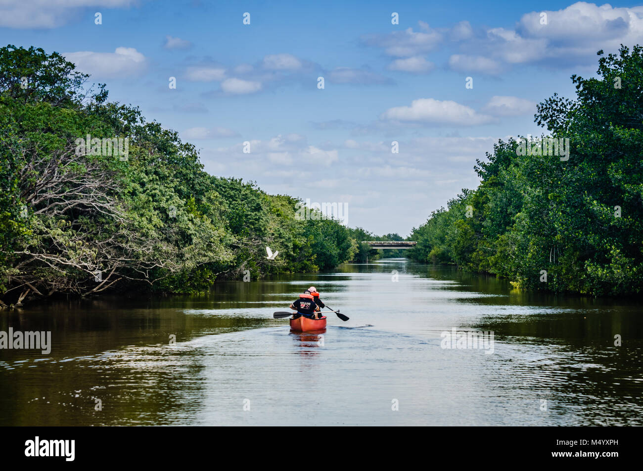 Family rows a red canoe on Biscayne Bay Lagoon at Biscayne National ...