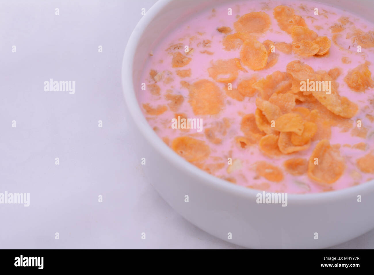 Bowl of fresh yogurt with granola and dried fruit. Isolated white ...