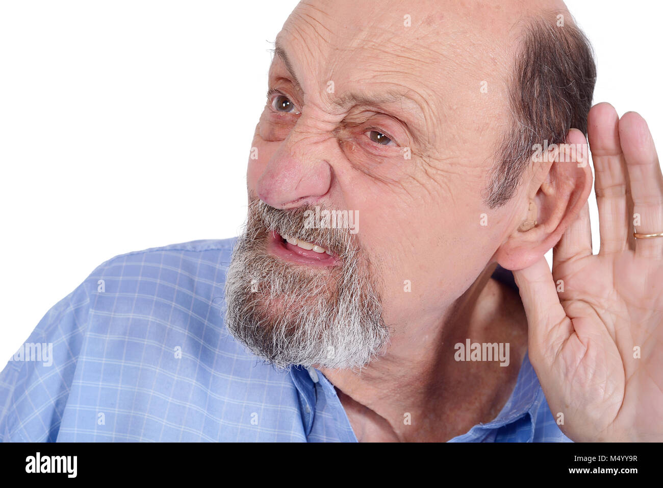 Portrait of deaf old man trying to listen. Isolated in a white ...