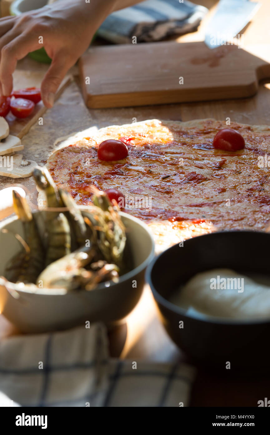 Unrecognizable woman cooking pizza at home Stock Photo - Alamy