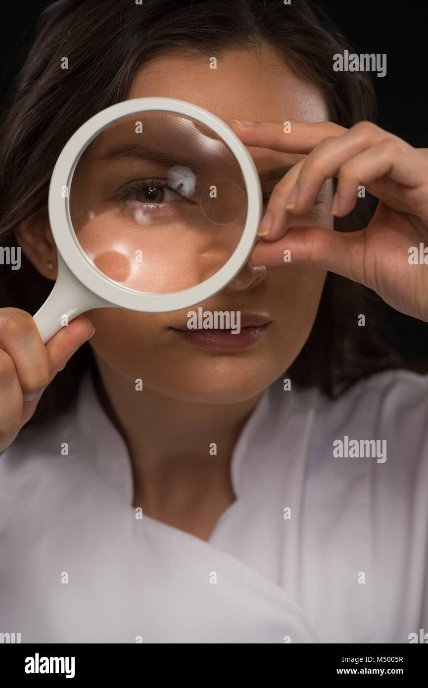Doctor Looking Through Magnifying Glass Stock Photo - Alamy
