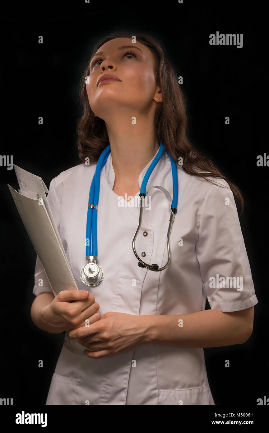 Female doctor reading medical record Stock Photo - Alamy
