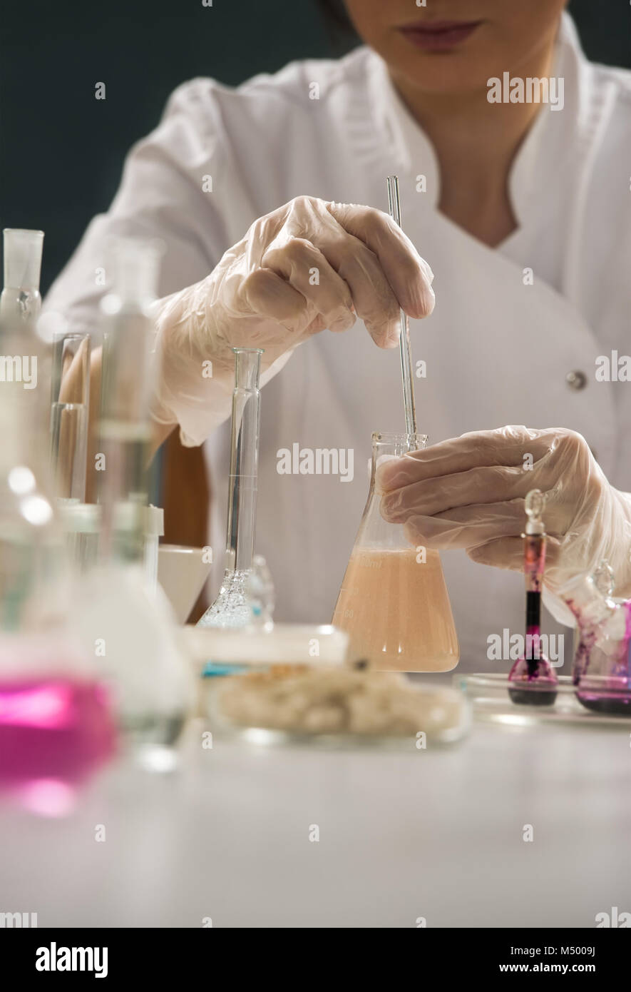 Unrecognizable science professional working with the glass cuvette ...