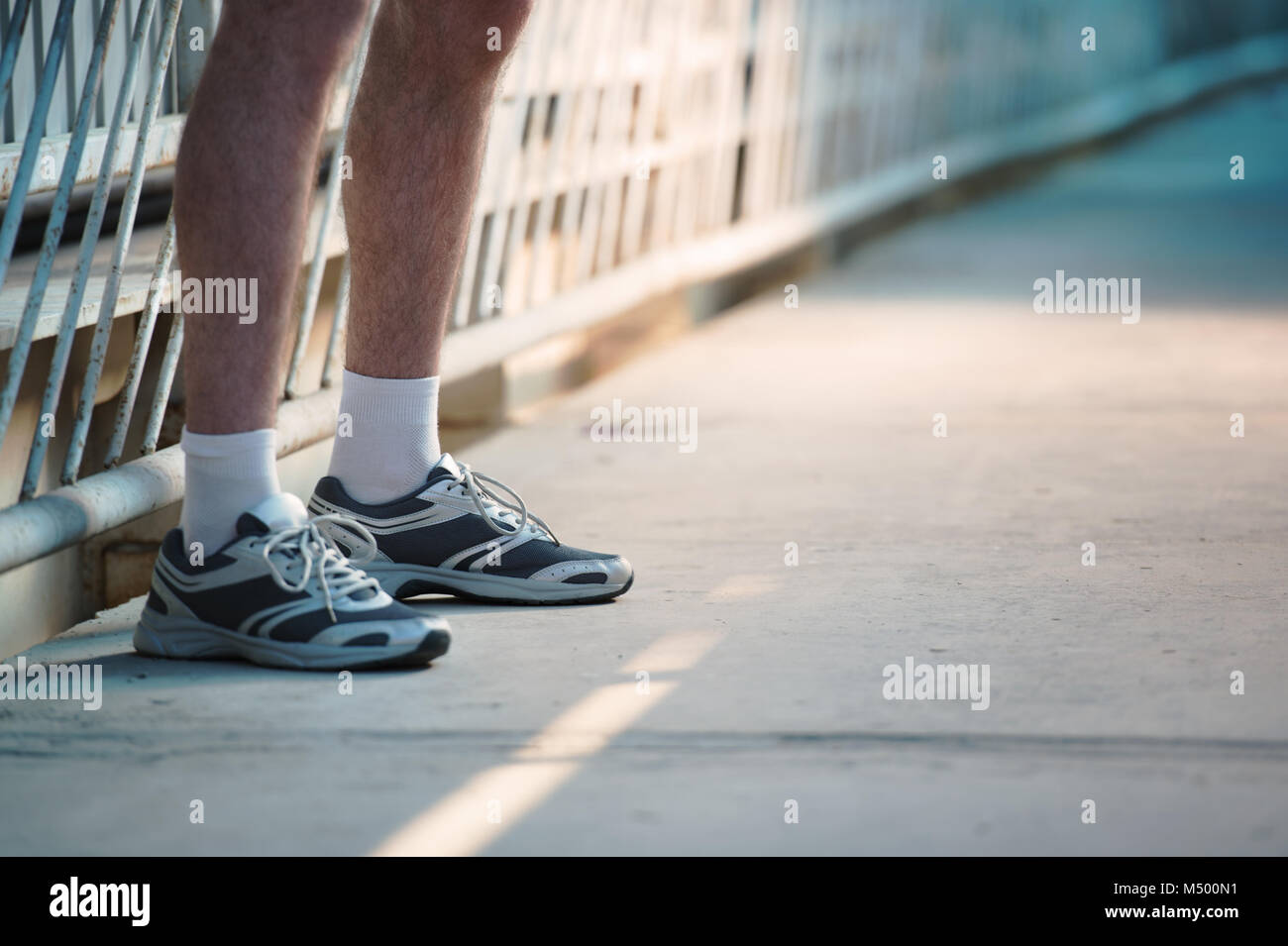 Unrecognizable man with athletic pair of legs going for jog or run ...