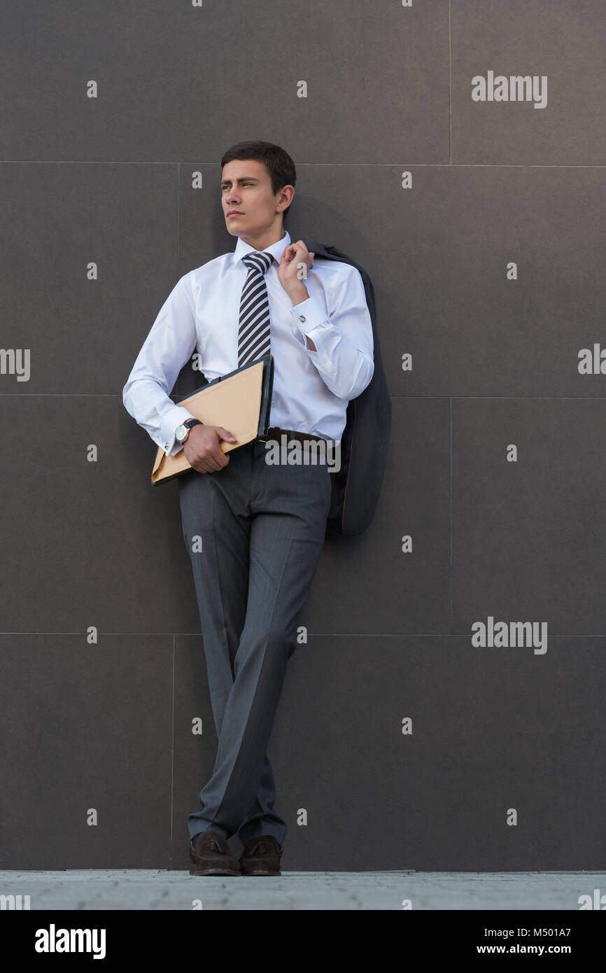 Portrait of pensive and confident adult businessman, wearing suit and ...