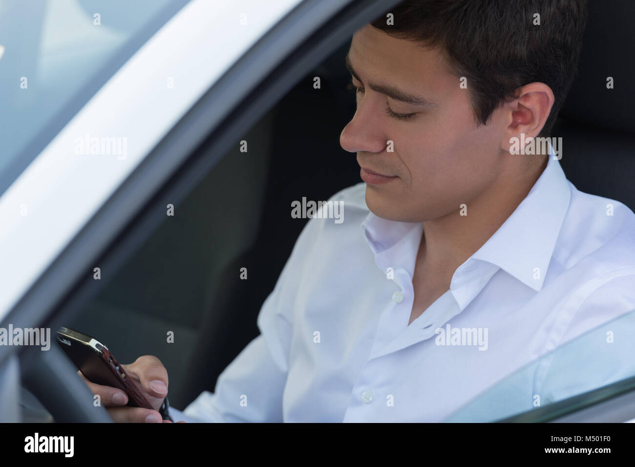 The young man behind the wheel driving car and calling phone Stock ...