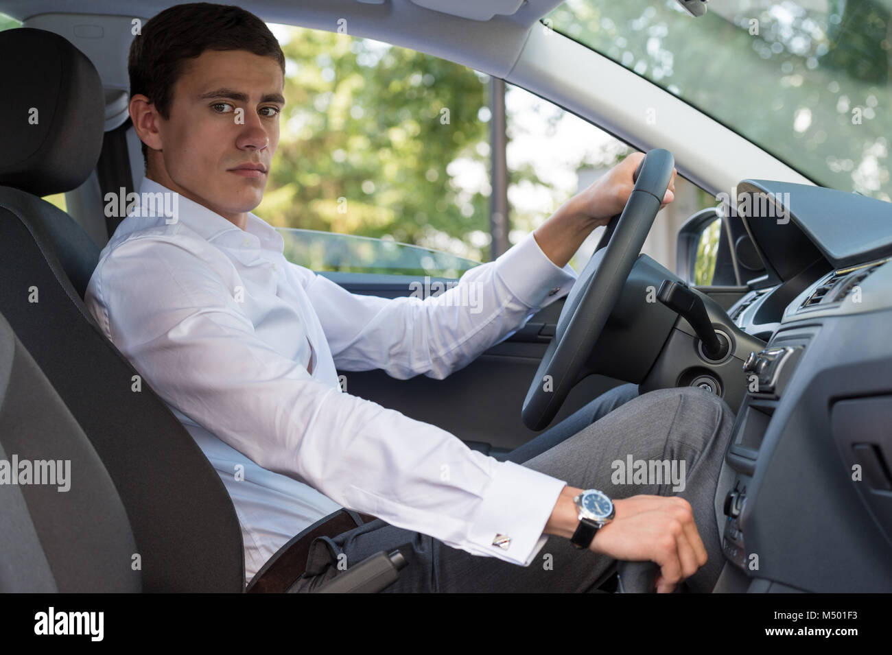 The young man behind the wheel driving car Stock Photo - Alamy