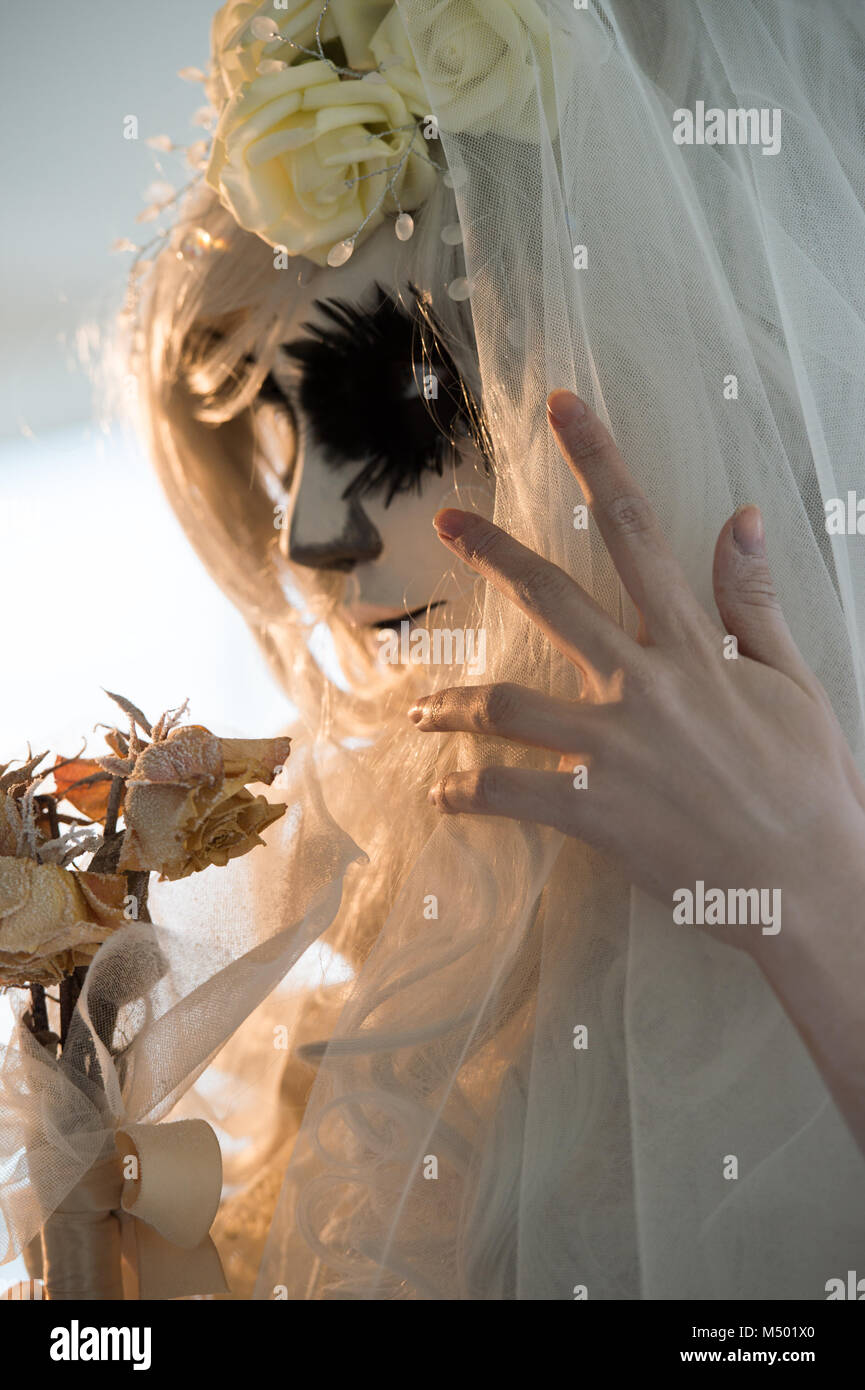 Halloween witch. Beautiful bride woman wearing santa muerte mask and ...