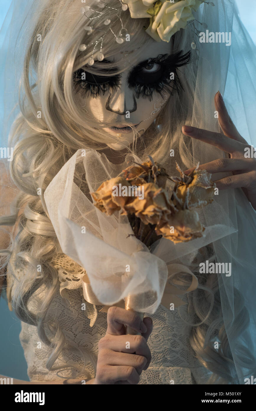 Halloween witch. Beautiful bride woman wearing santa muerte mask and ...