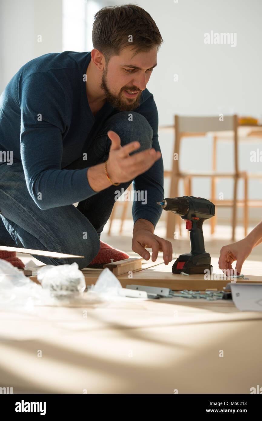 Man Putting Together Self Assembly Furniture In New Home Stock Photo ...
