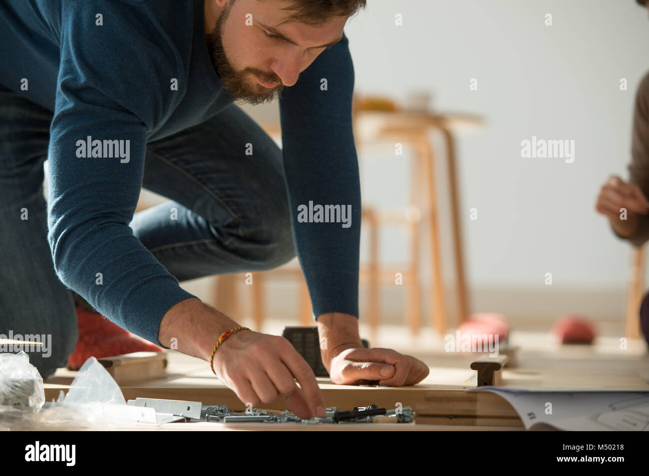 Man Putting Together Self Assembly Furniture In New Home Stock Photo ...