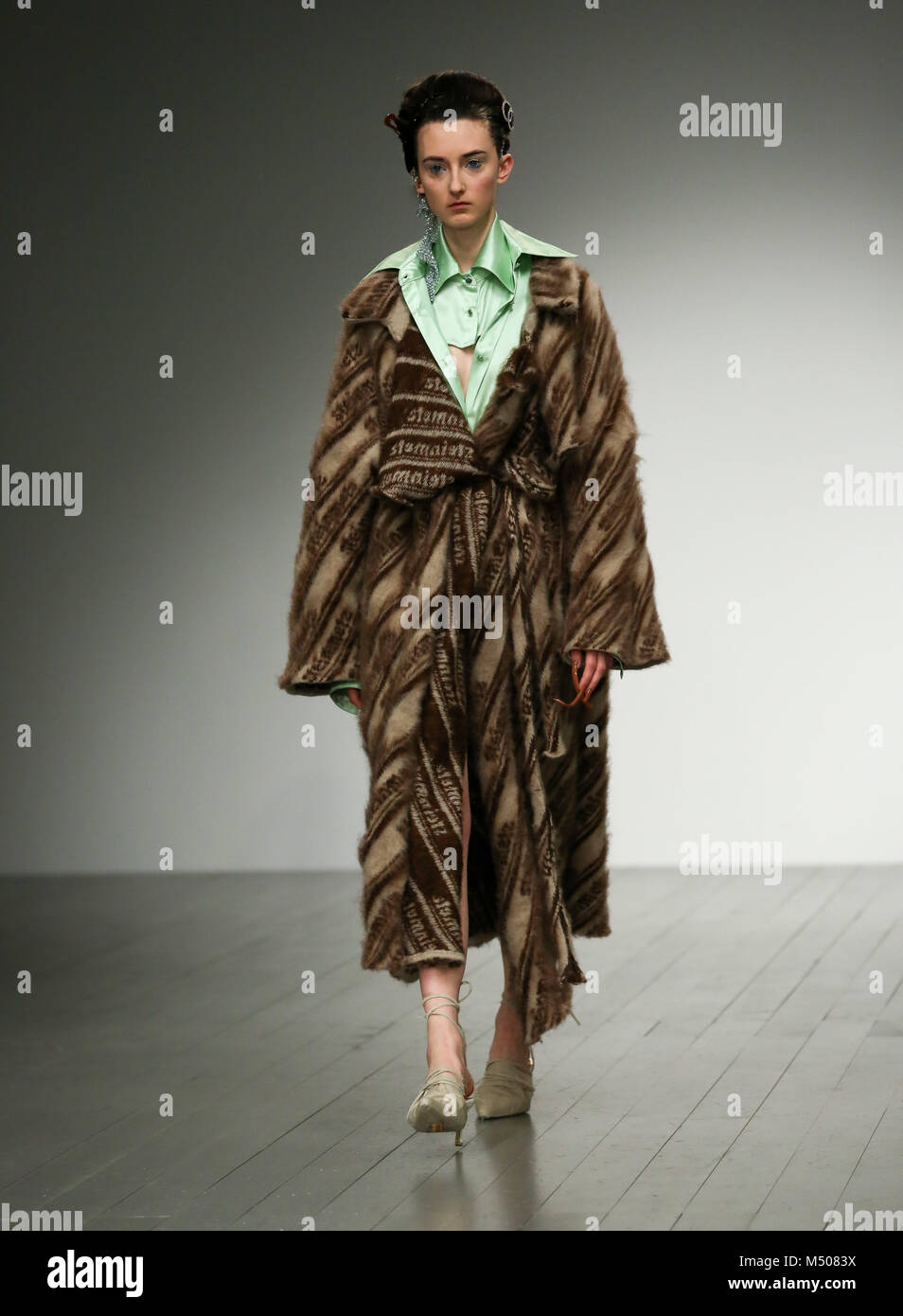 London, UK. 19th Feb, 2018. A model walk the runway at the Faustine ...