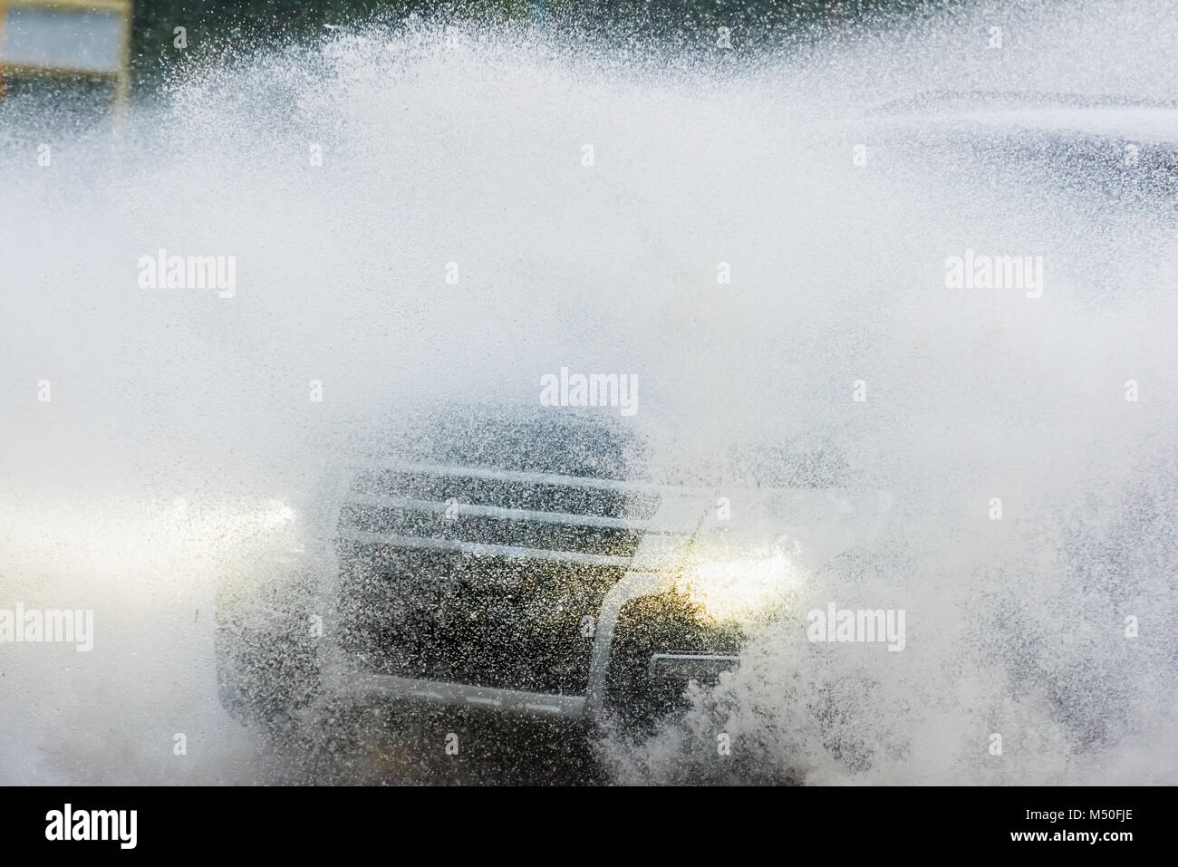 car rain puddle splashing water Stock Photo - Alamy