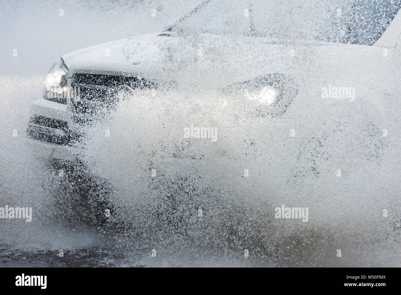 car rain puddle splashing water Stock Photo - Alamy