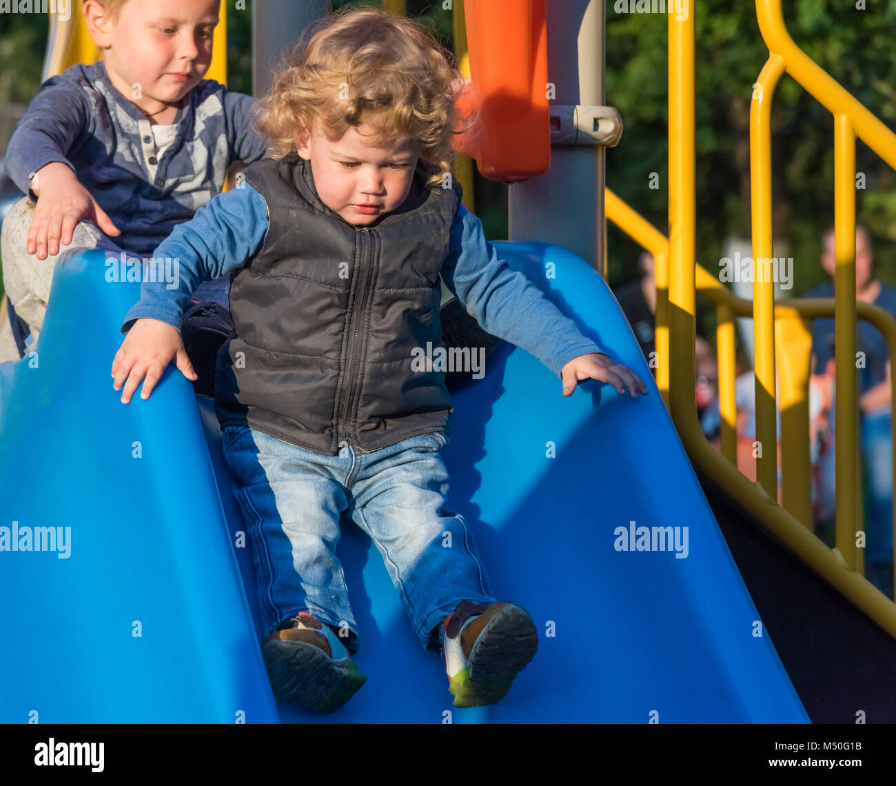 Two brothers on the playground Stock Photo - Alamy