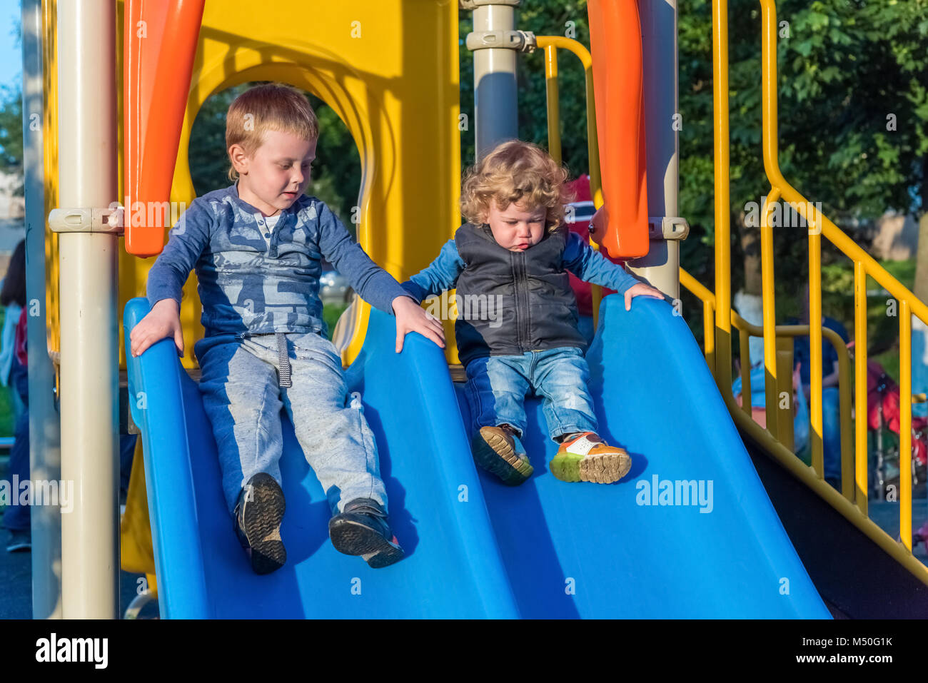 Two brothers on the playground Stock Photo - Alamy