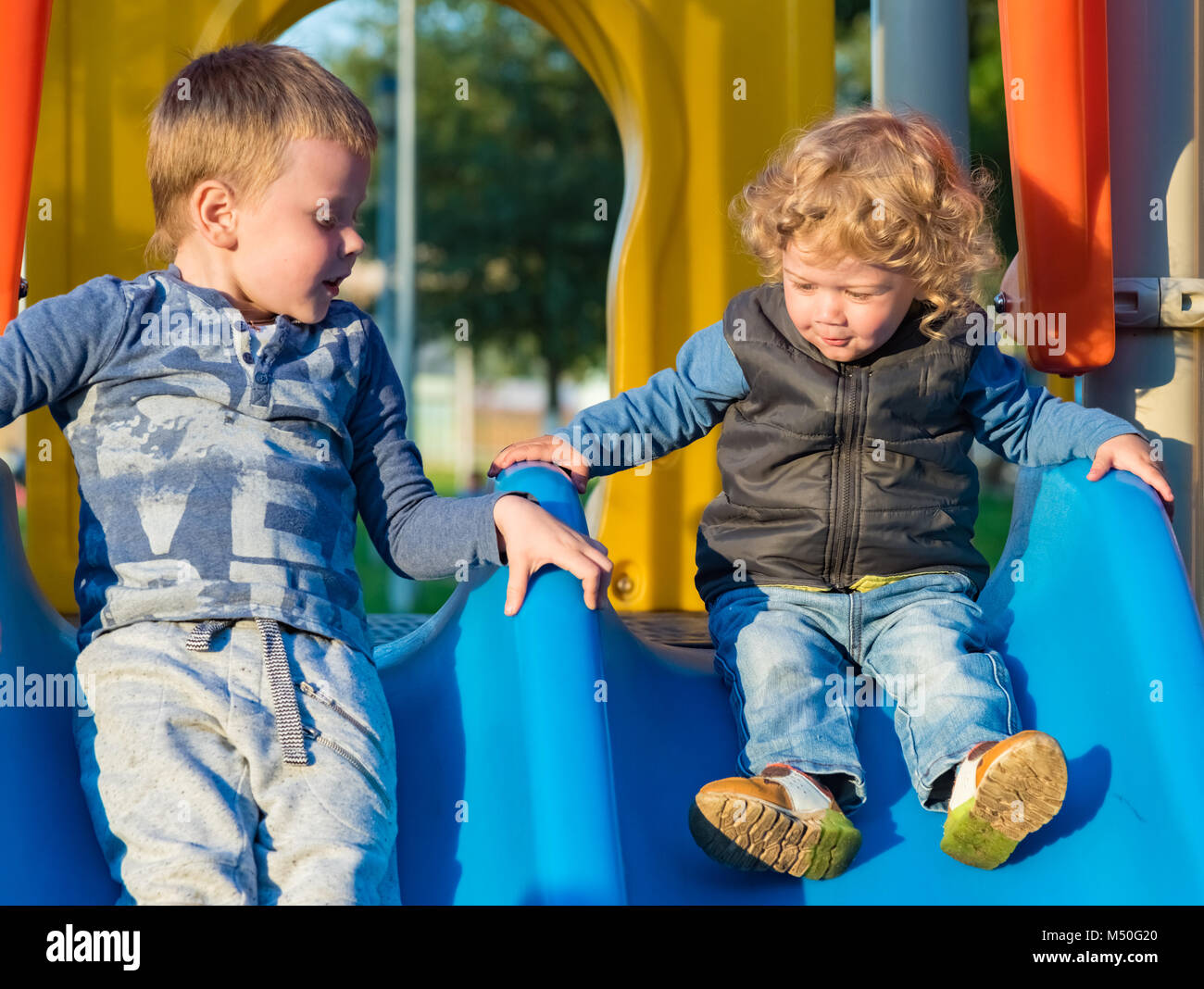 Two brothers on the playground Stock Photo - Alamy