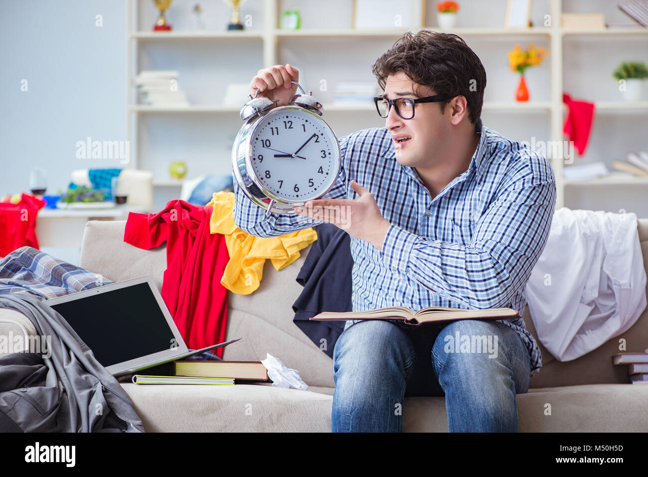 Young man working studying in messy room Stock Photo - Alamy