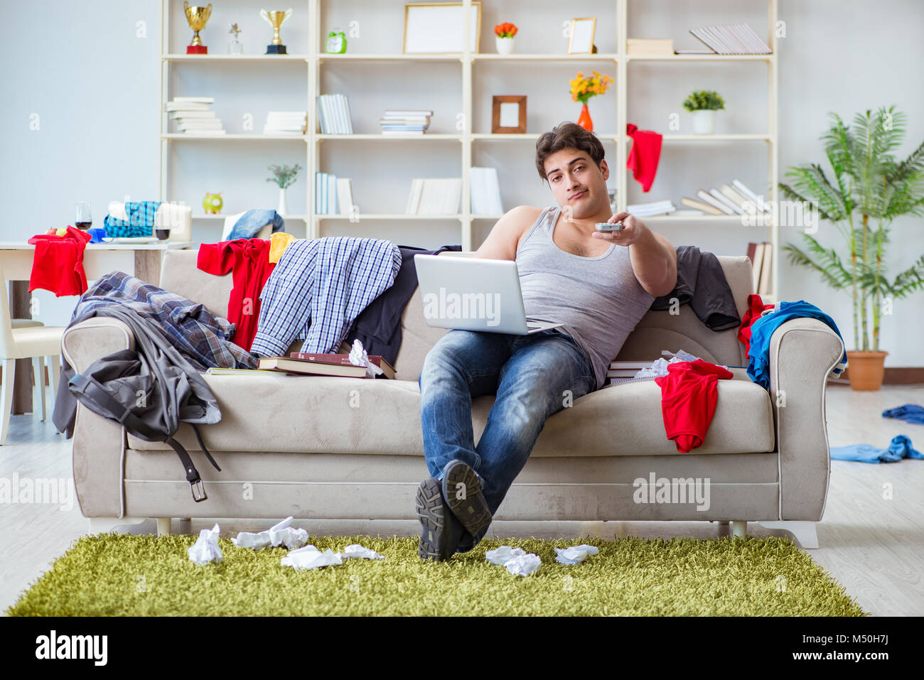 Young man working studying in messy room Stock Photo - Alamy