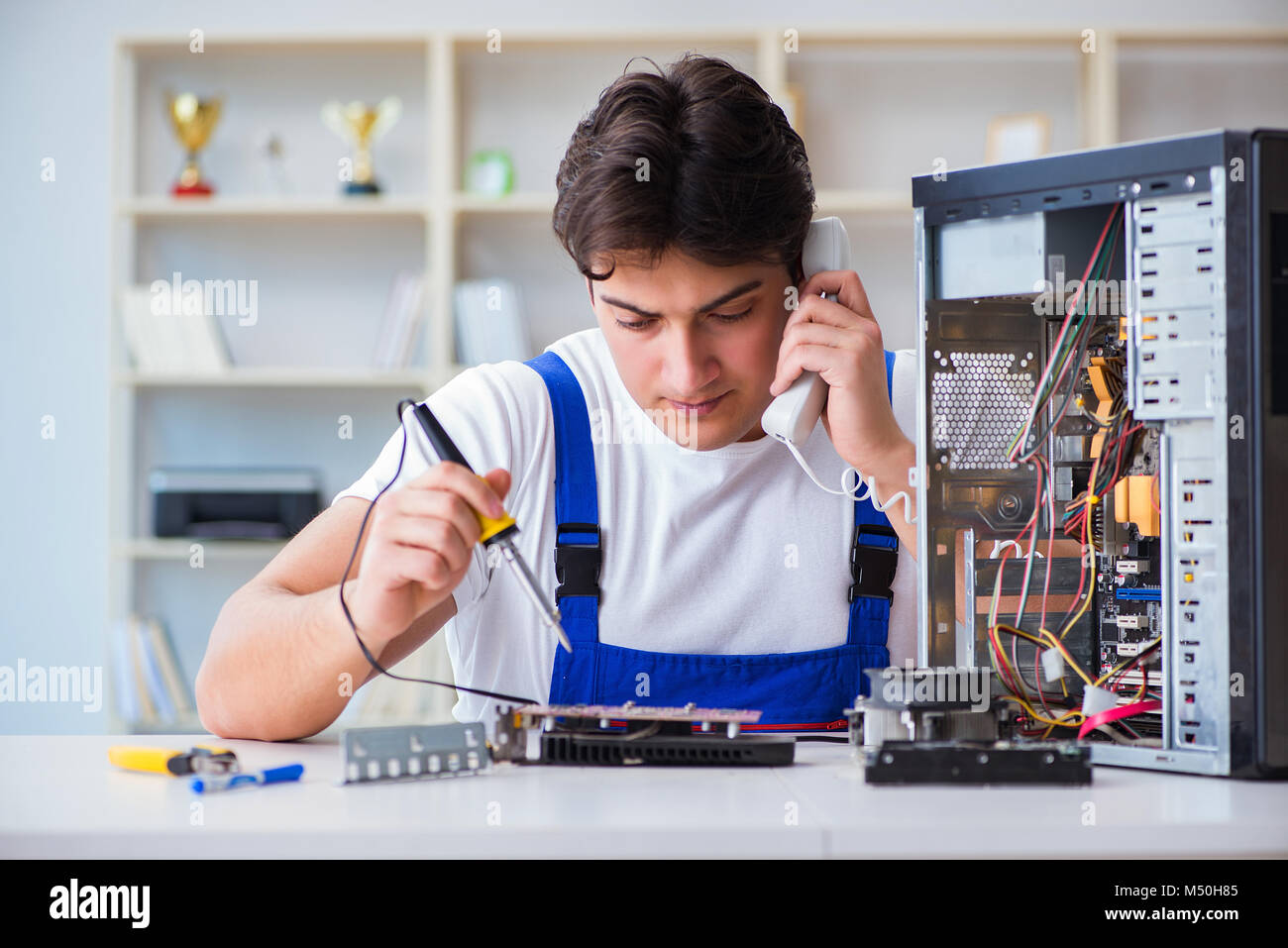 Computer repairman repairing desktop computer Stock Photo - Alamy