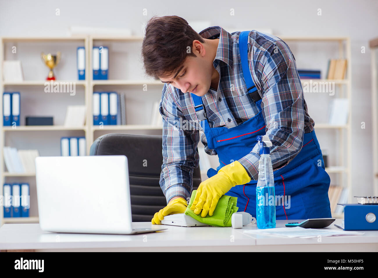Male cleaner working in the office Stock Photo - Alamy