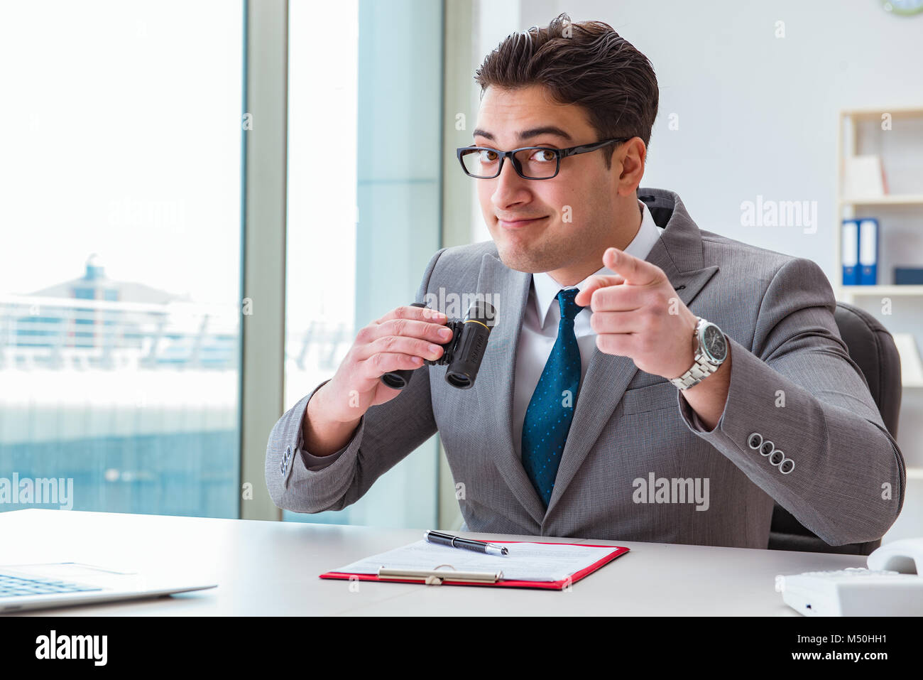 Man looking for errors and mistakes in report Stock Photo - Alamy