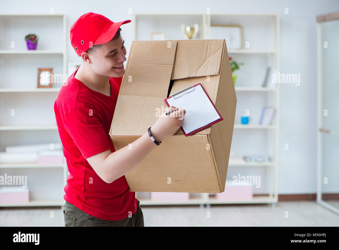 Post man delivering a parcel package Stock Photo - Alamy