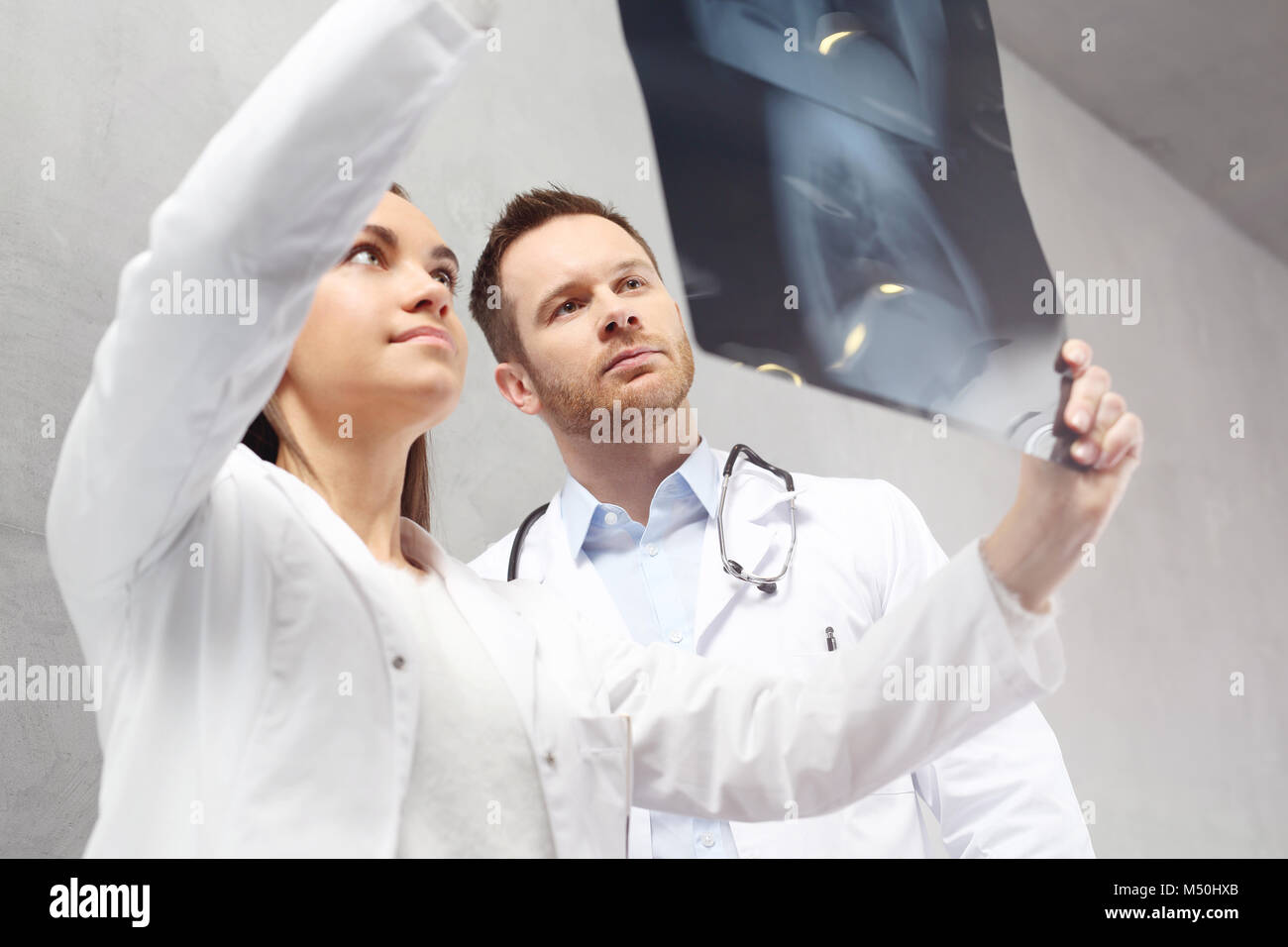 Pulmonologist, medical consultation. Doctors are looking at the patient ...