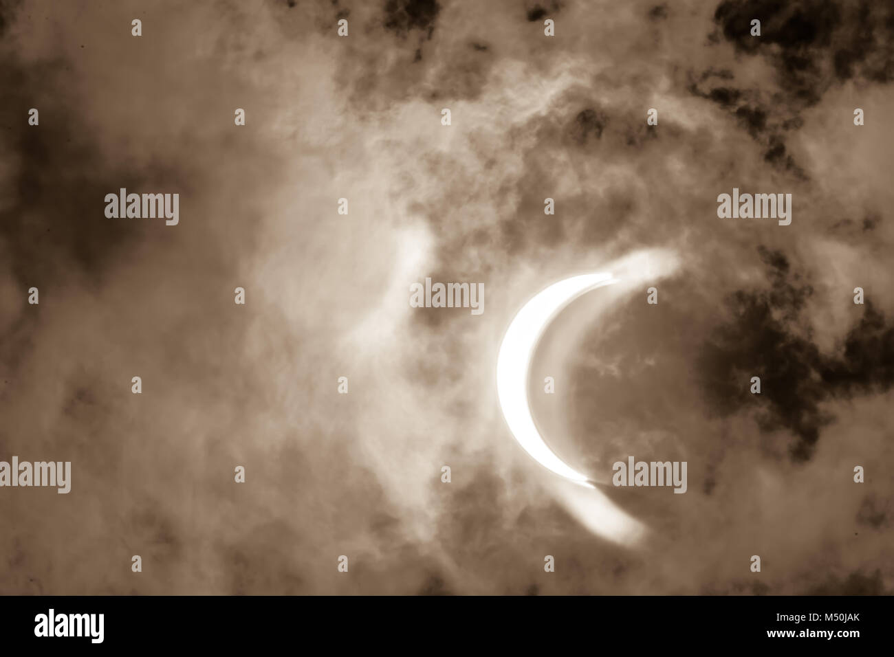 Partial Solar Eclipse Through Clouds Stock Photo - Alamy