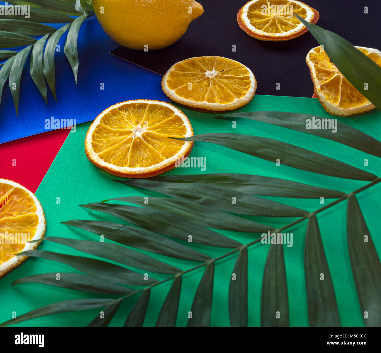 palm leaves and citrus fruits on colorful background Stock Photo - Alamy