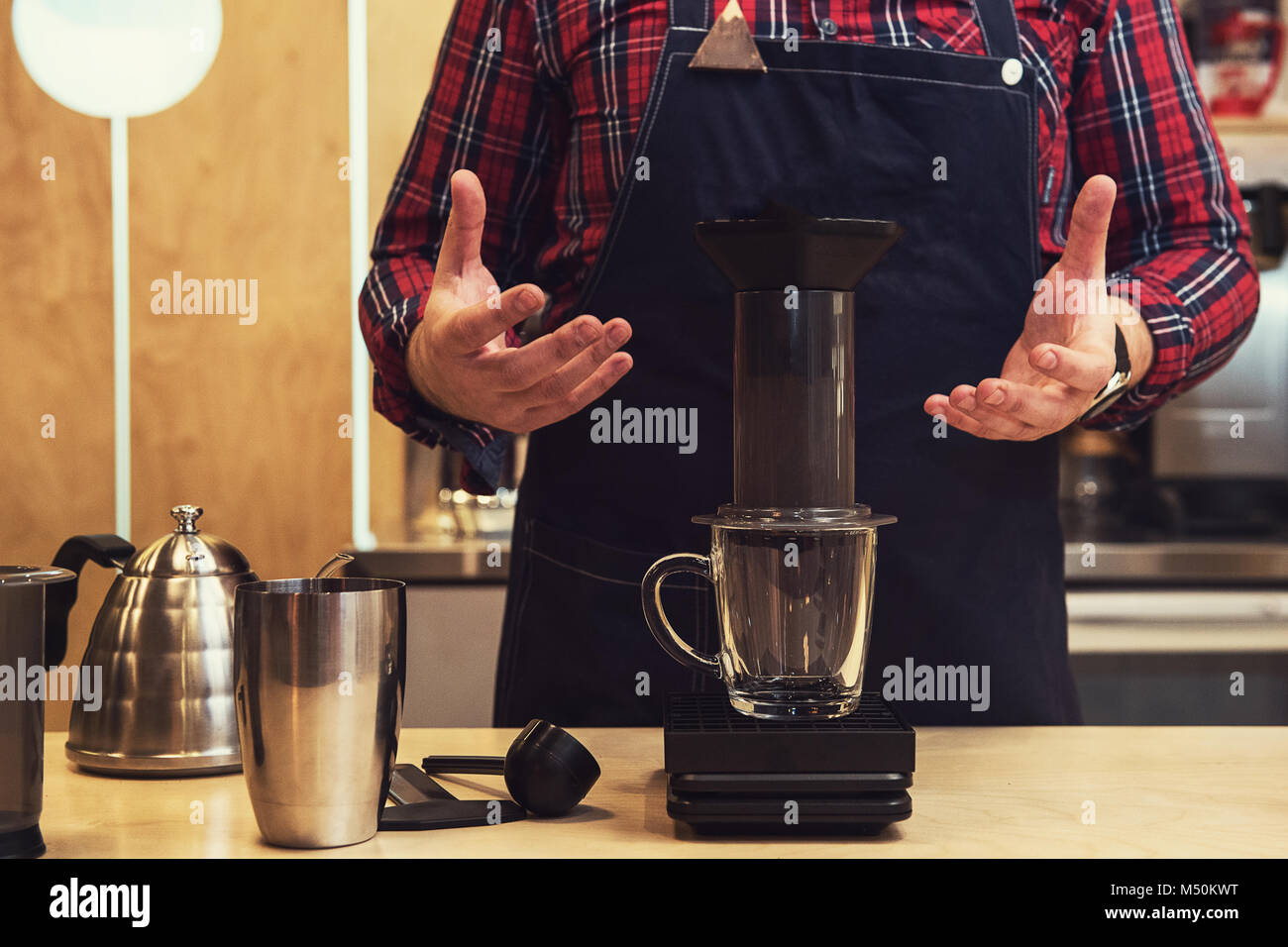 Barista brewing aeropress coffee Stock Photo - Alamy