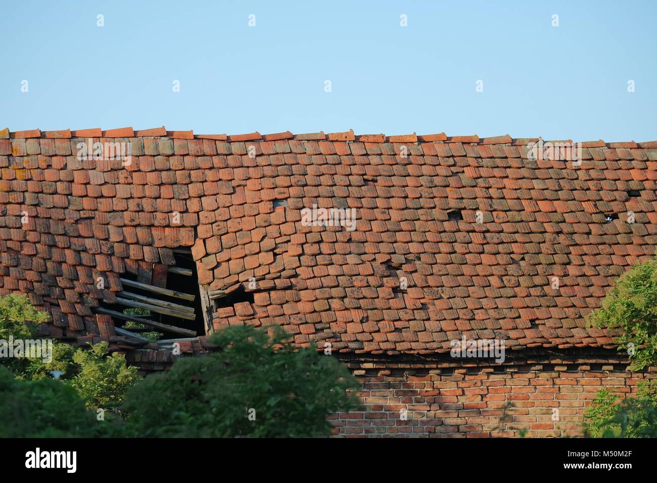Damaged brick roof Stock Photo - Alamy