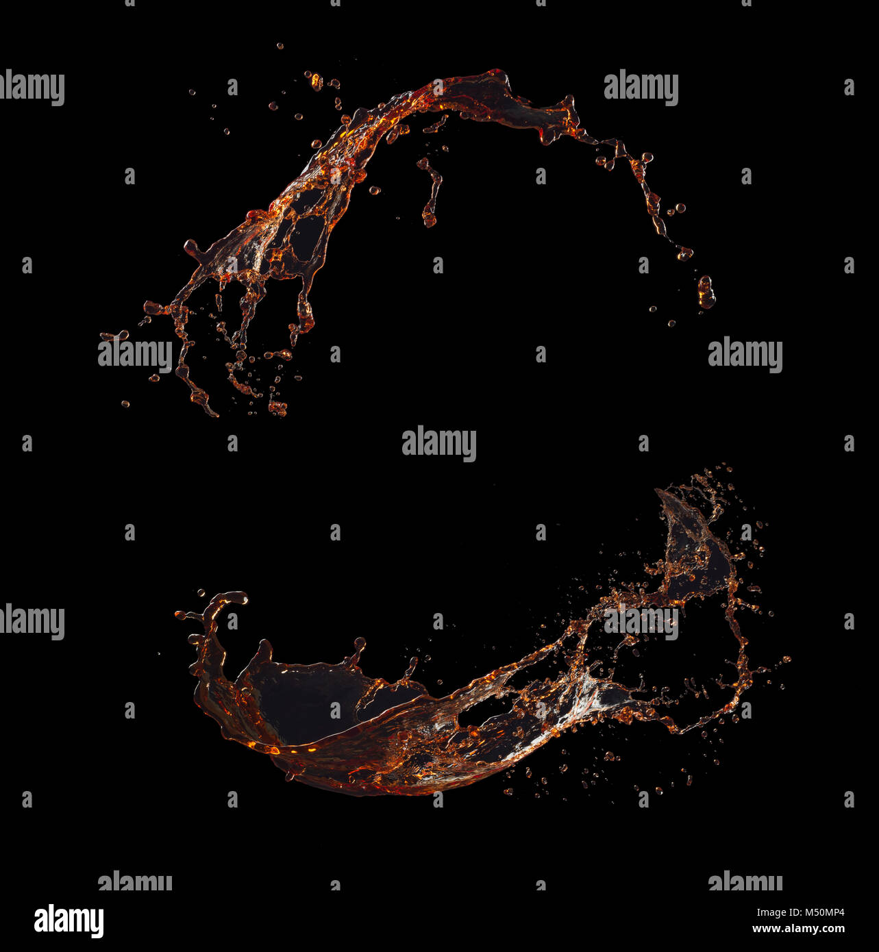 splash of ink isolated on black background. golden splash close-up ...