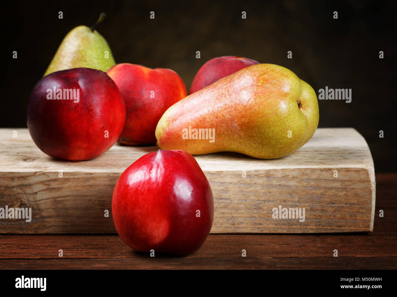 Peach and pear closeup on a rural table Stock Photo - Alamy