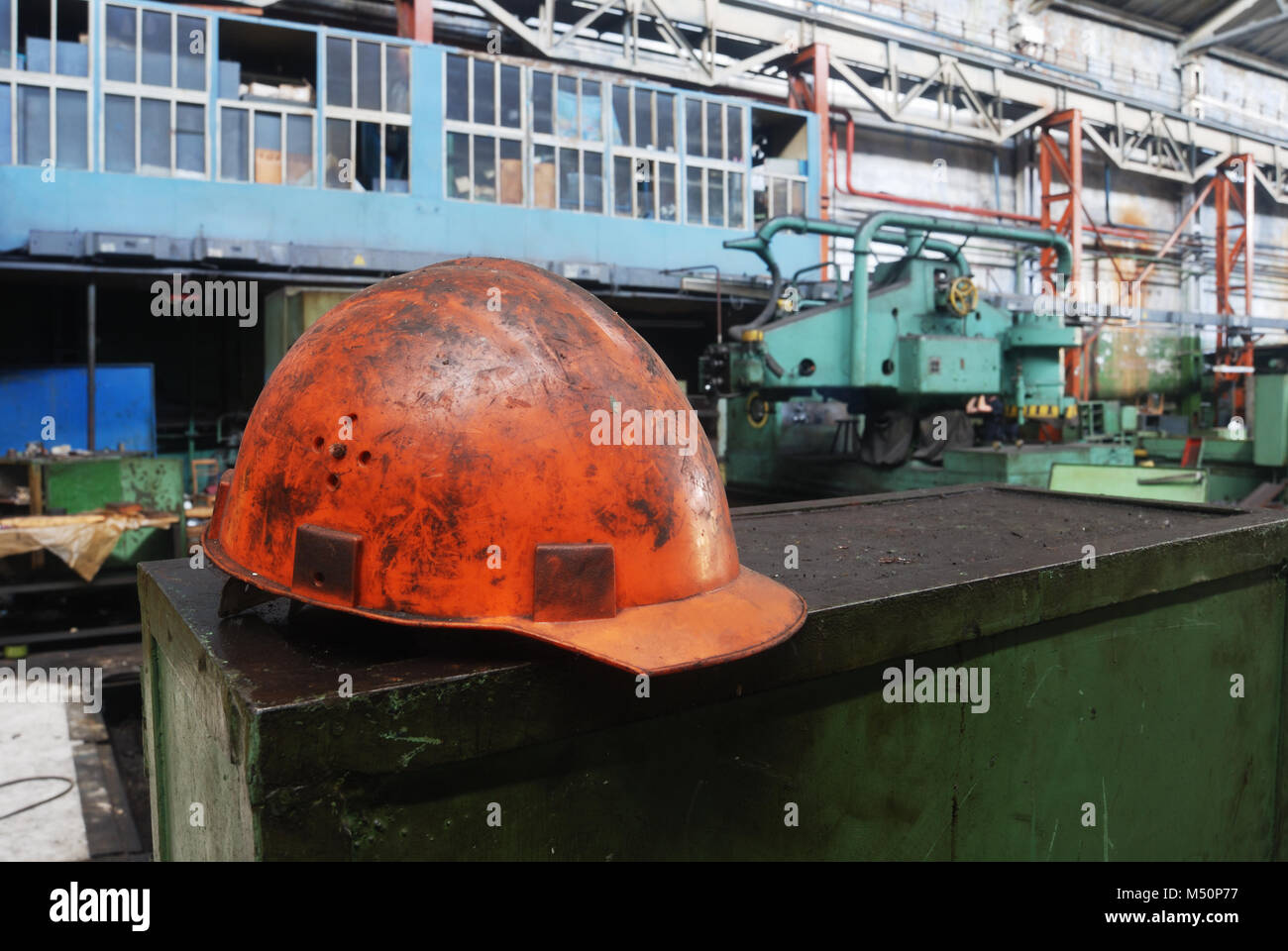 dirty orange helmet Stock Photo - Alamy