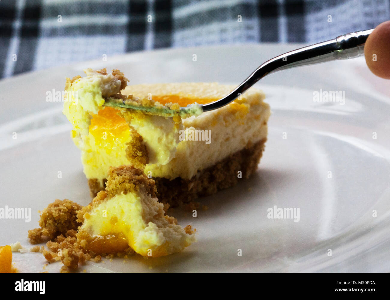 Diner takes a piece of Lemon cake on folk and about to eat it Stock ...