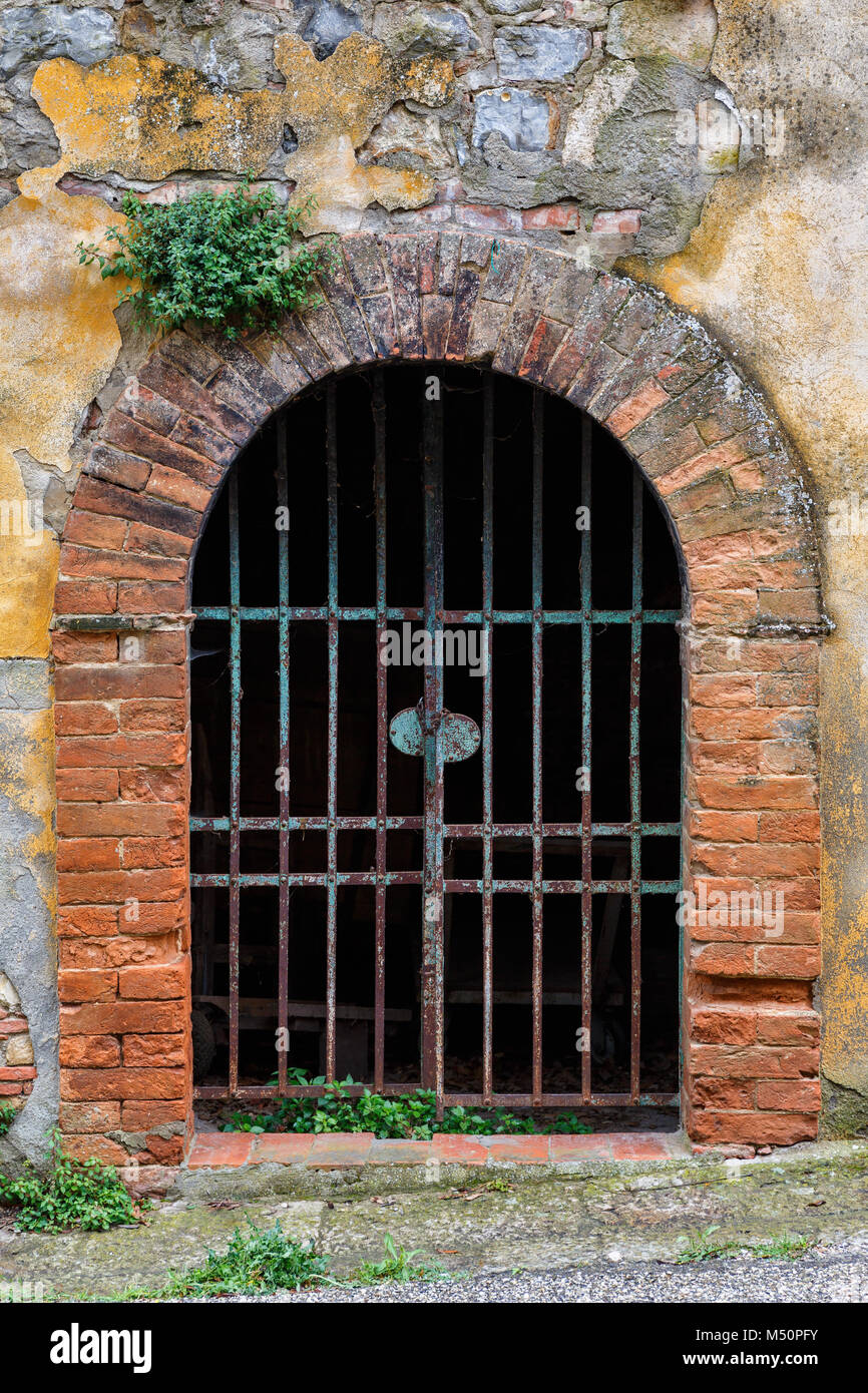 Closed old rusty iron gate Stock Photo - Alamy