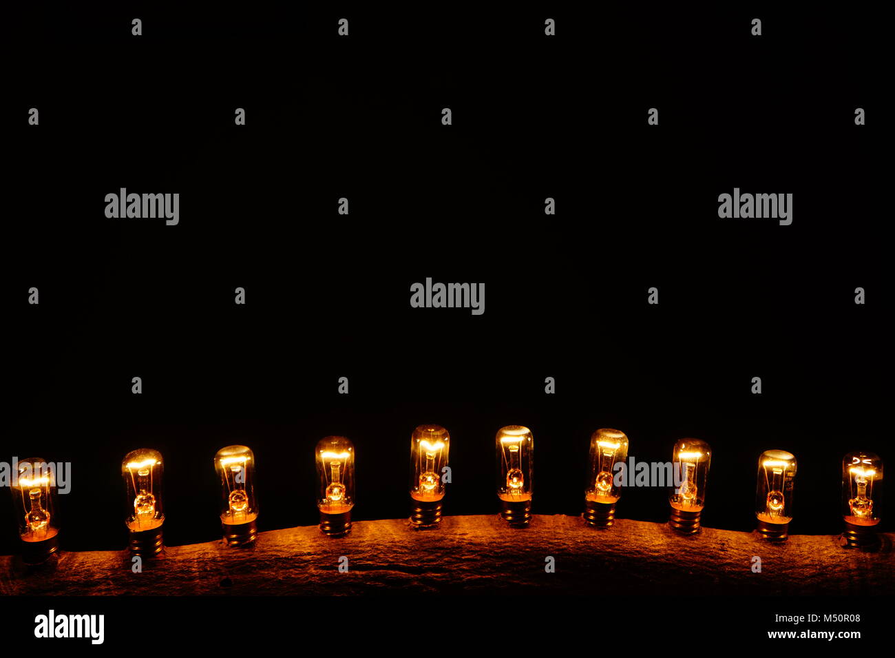 Light bulbs in tree branch in black bachground Stock Photo - Alamy