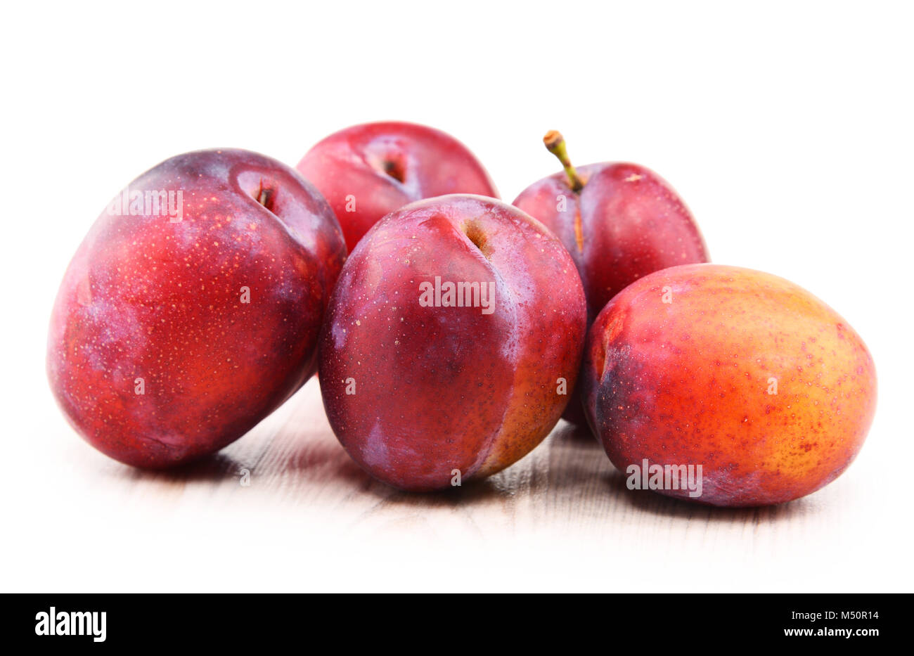 Composition with plums isolated on white background Stock Photo - Alamy