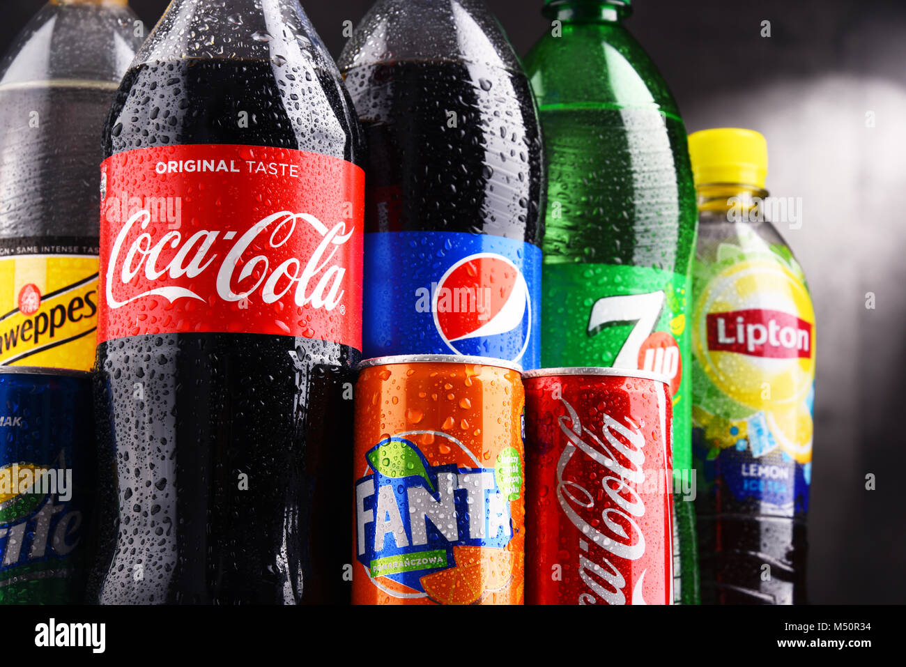 Bottles and cans of assorted global soft drinks Stock Photo - Alamy