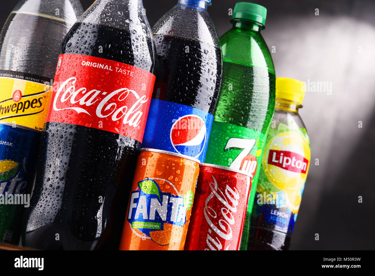 Bottles and cans of assorted global soft drinks Stock Photo - Alamy