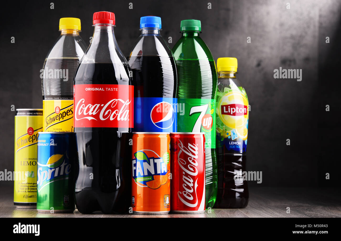 Bottles and cans of assorted global soft drinks Stock Photo - Alamy