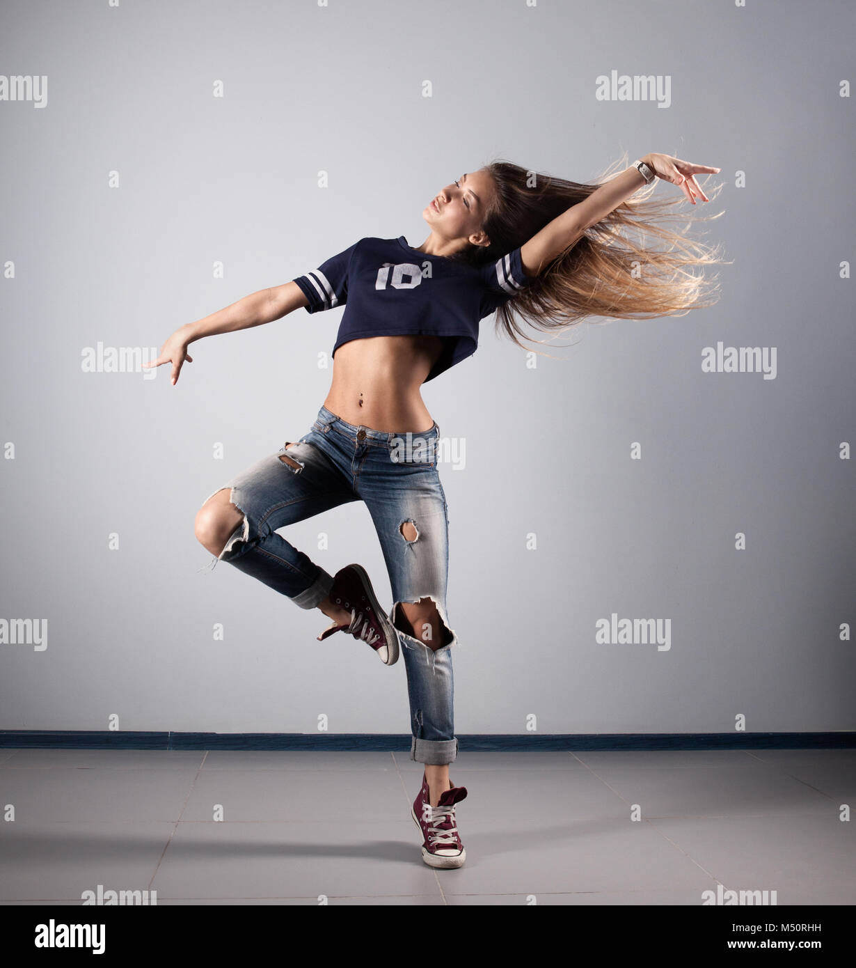 modern young beautiful dancer posing on a studio background Stock Photo ...
